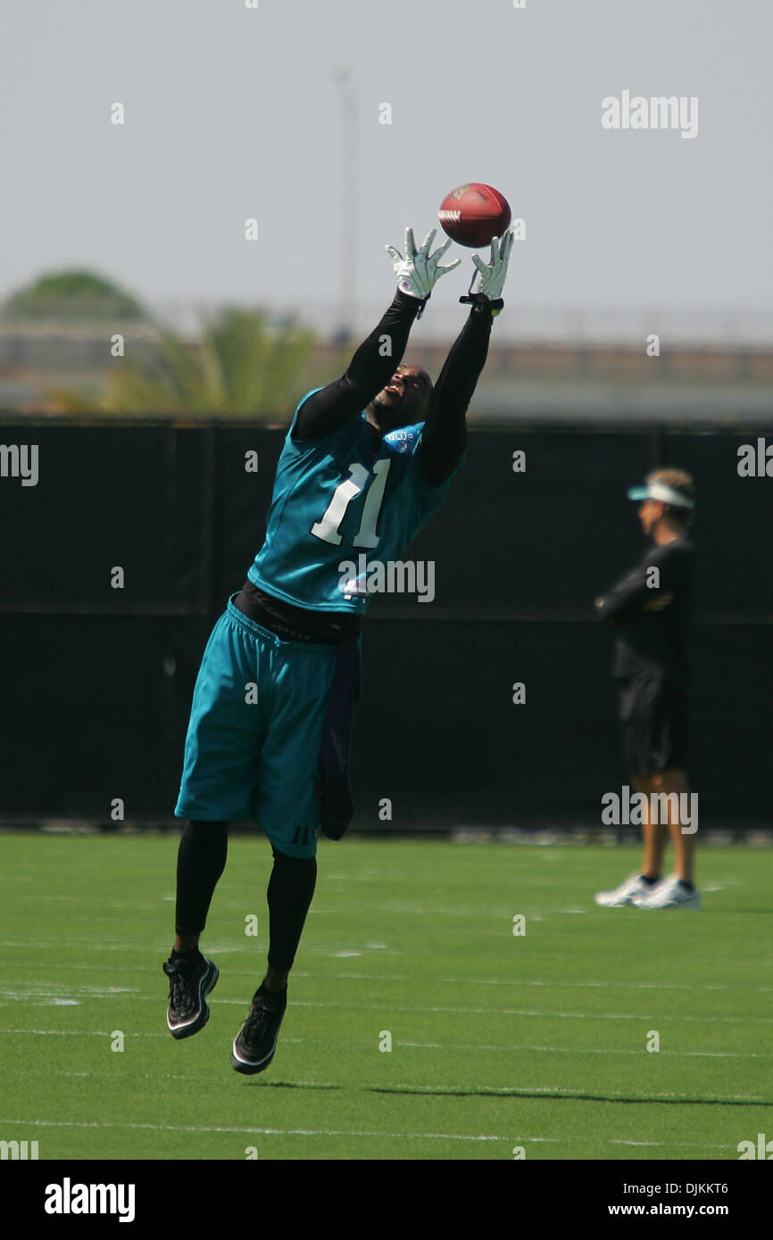 Mike Sims-Walker catches a pass during training camp at the ...