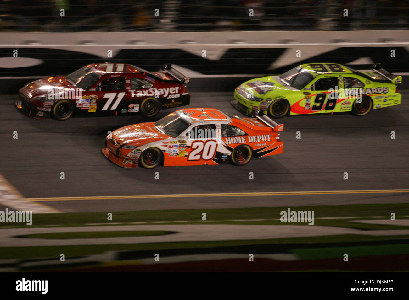 Bobby Labonte, (71), Joey Logano (20) and Paul Menard (98) race during ...