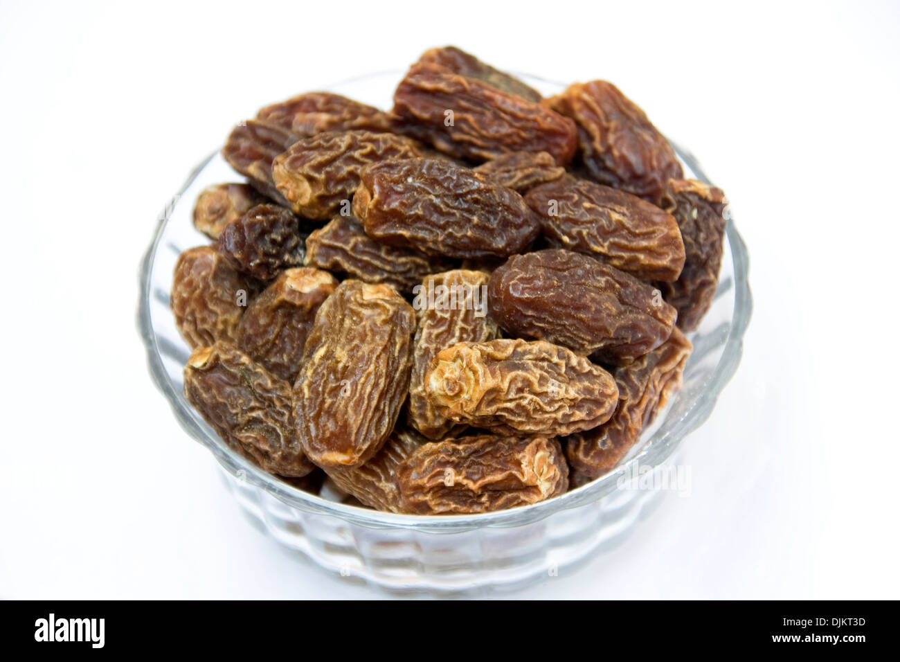 Sweet, energetic dry dates in a cup, isolated on white Stock Photo - Alamy