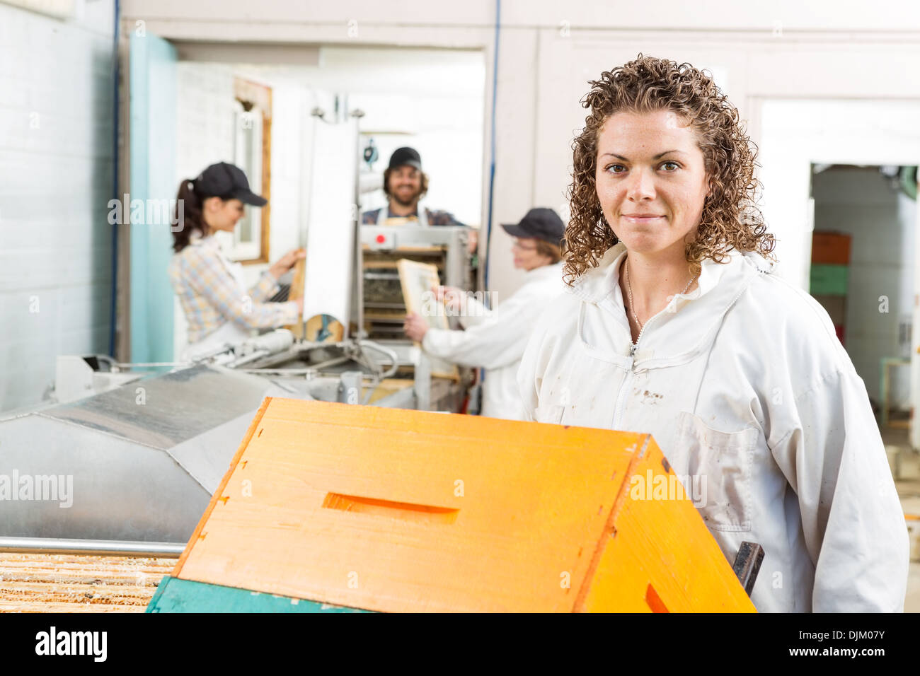 Female Beekeeper With Stacked Honeycomb Crates Stock Photo - Alamy