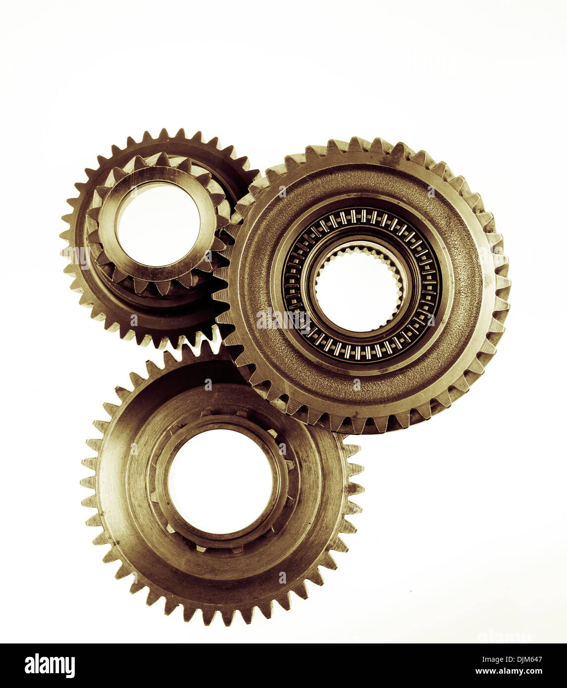 Metal cog gears joining together Stock Photo - Alamy