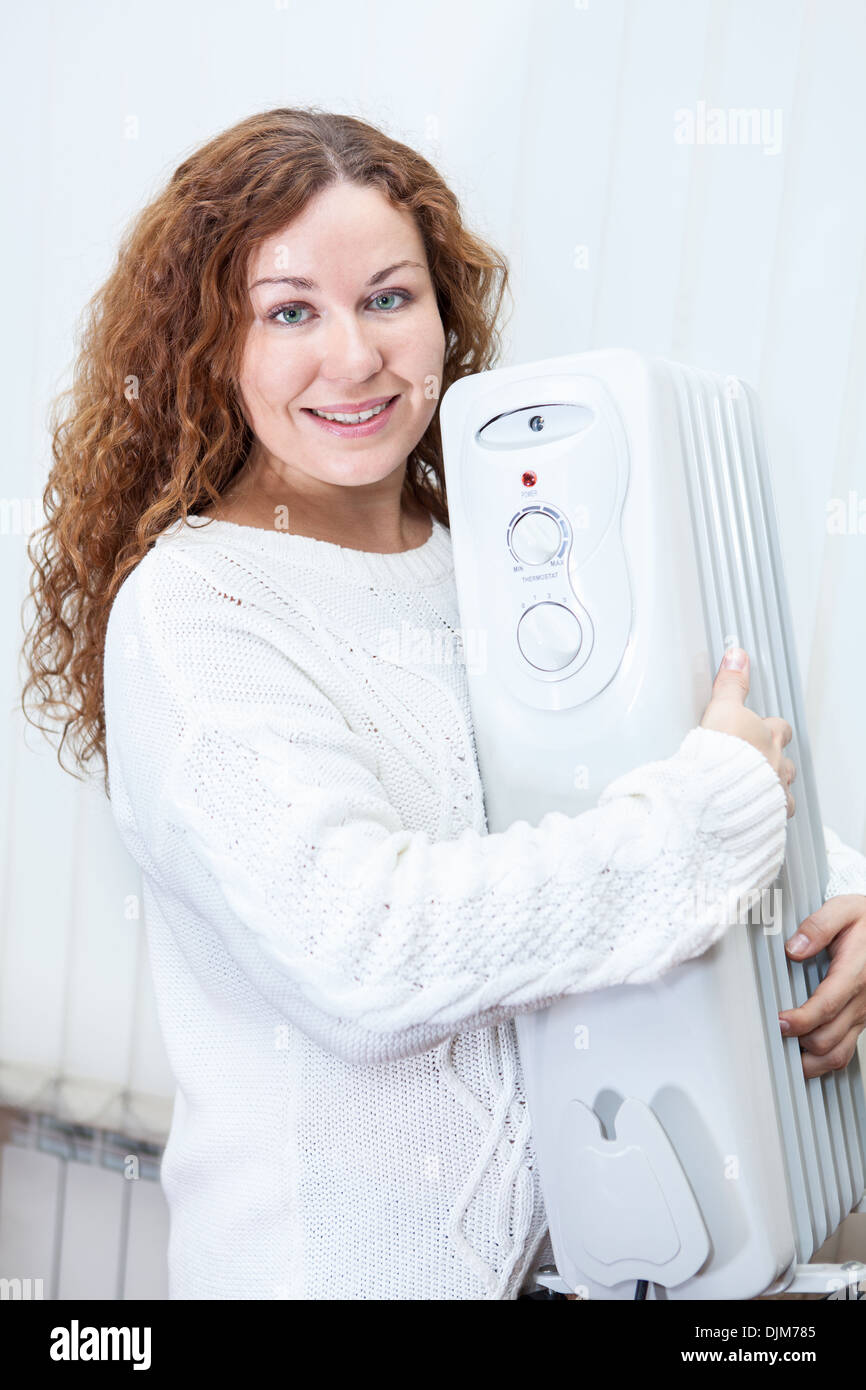 Woman holding radiator in hands Stock Photo - Alamy