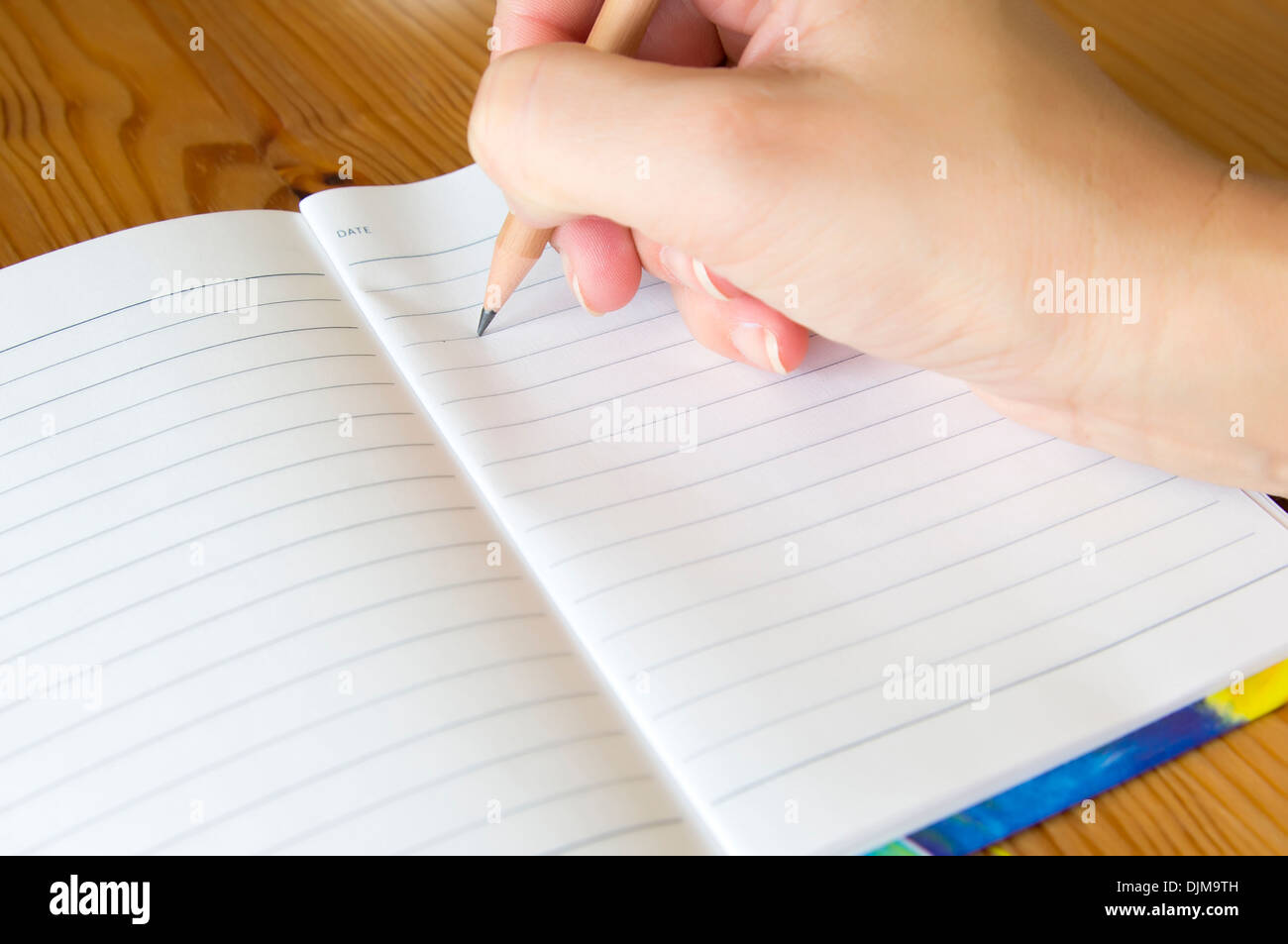 female hand holding a pencil to take notes Stock Photo - Alamy