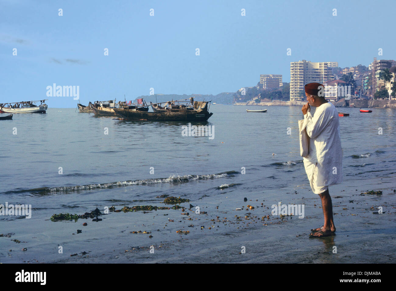 Pensive man wearing traditional dress at waters edge Mumbai India Stock ...