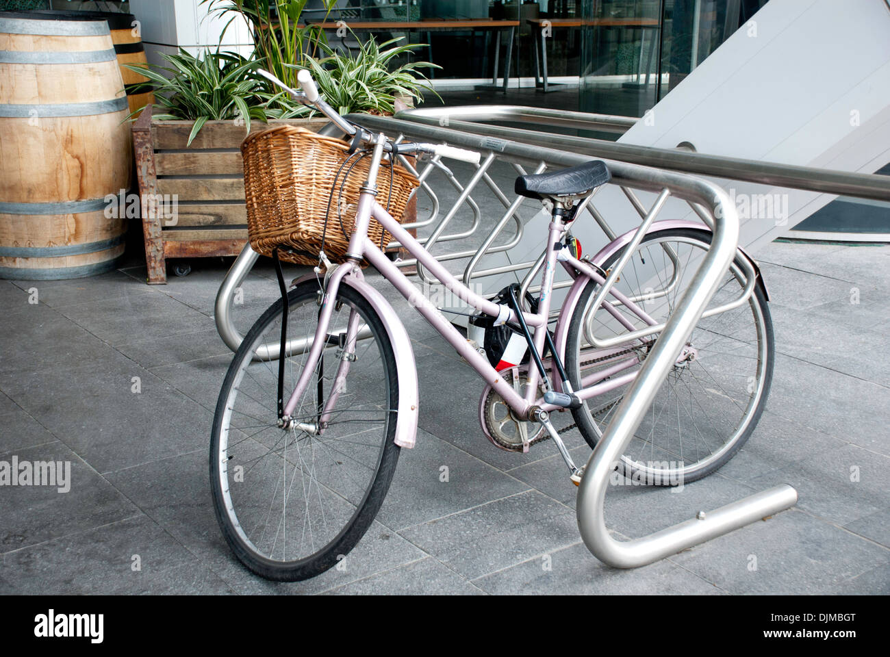 Ladies bicycle parked at a bike rack Stock Photo - Alamy