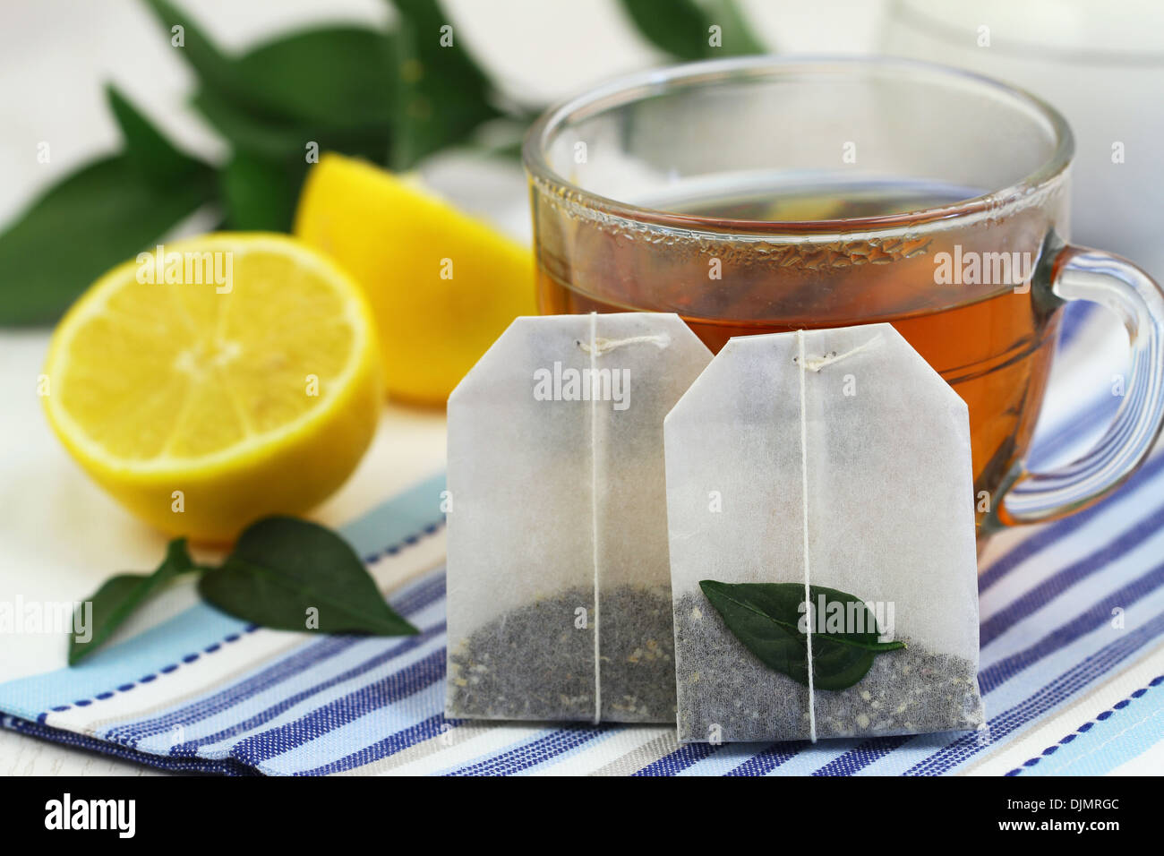 Tea bags, tea and fresh lemon Stock Photo - Alamy