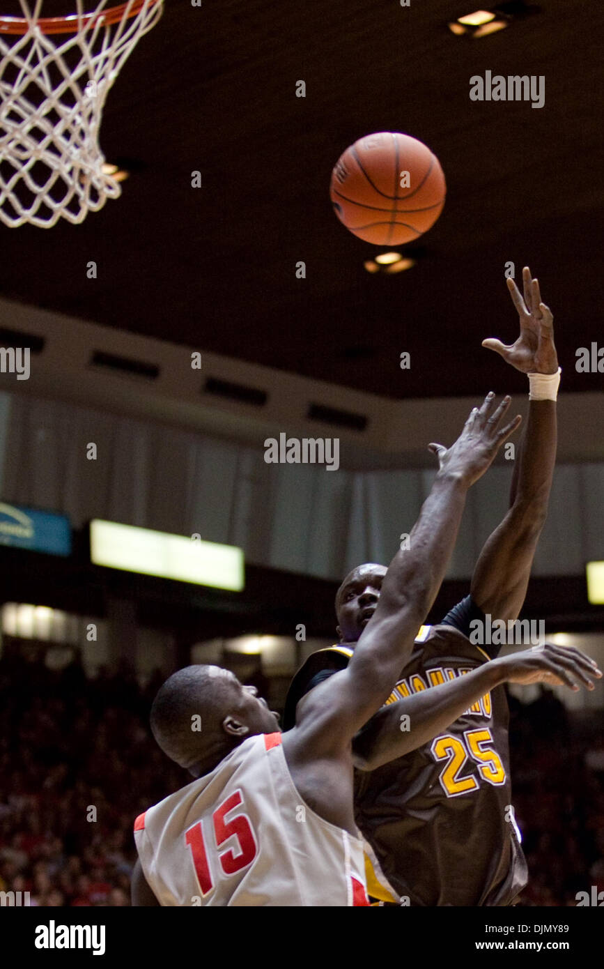 University of Wyoming forward Djibril Thiam (25) takes a one handed shot over forward Will Brown ...
