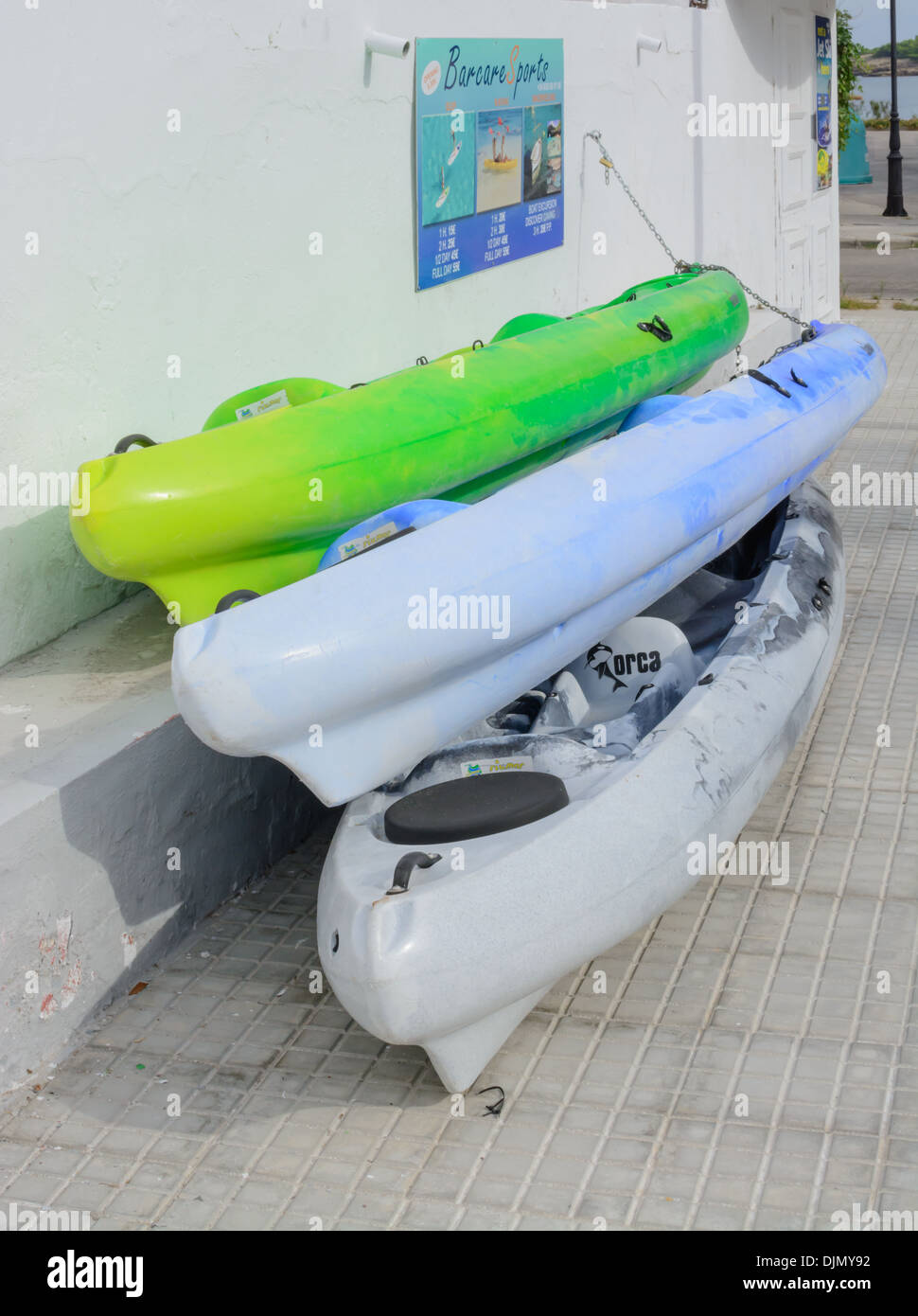 Stack of kayaks leaning against a wall in the last days of summer ...