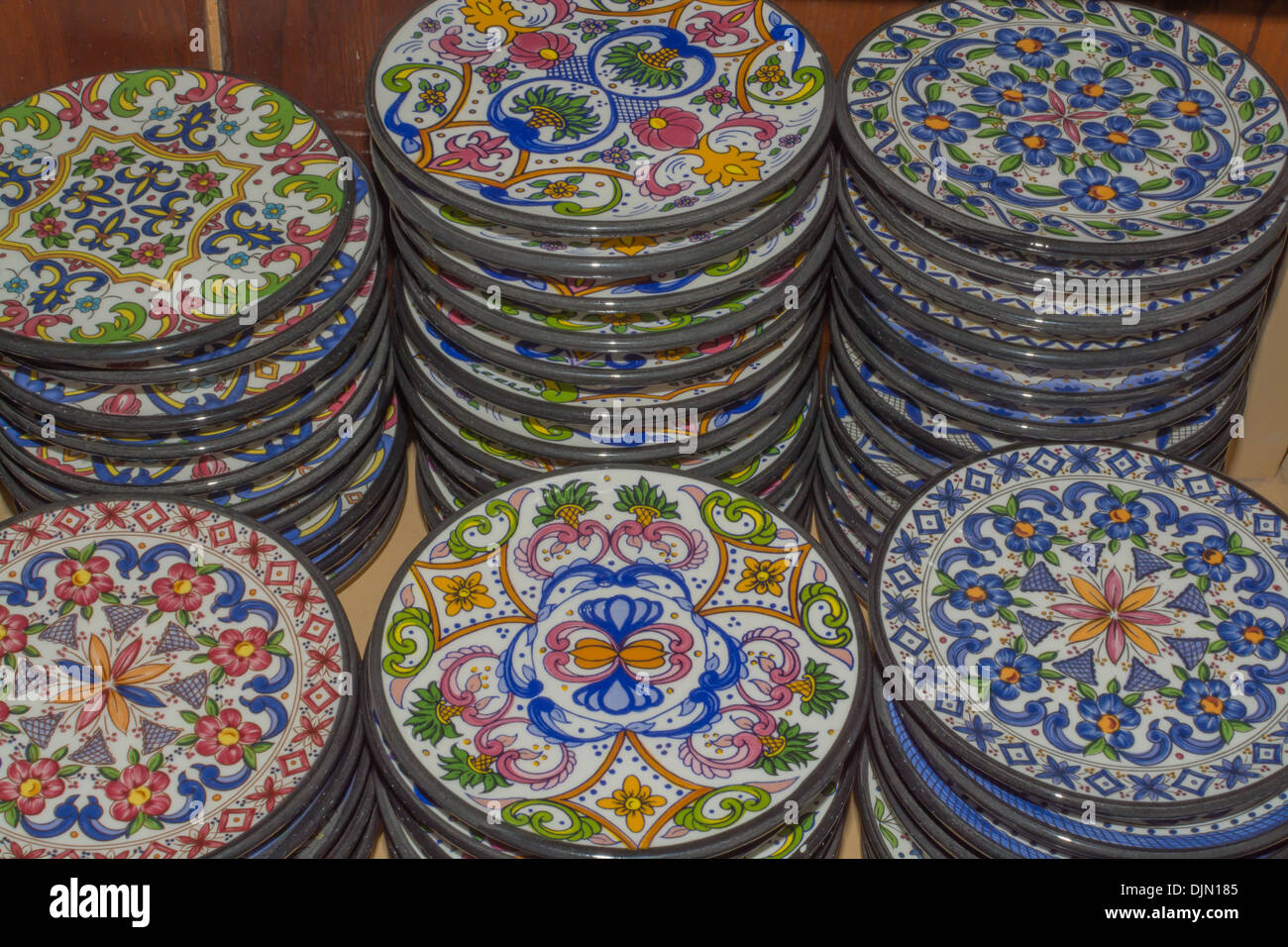 Small colorful plates of stoneware stacked in a store Stock Photo - Alamy