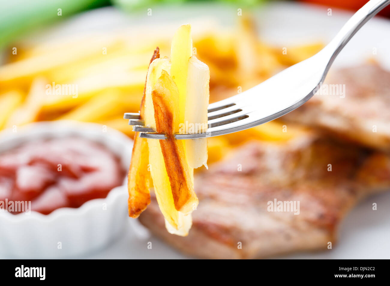 French fries on a fork Stock Photo - Alamy