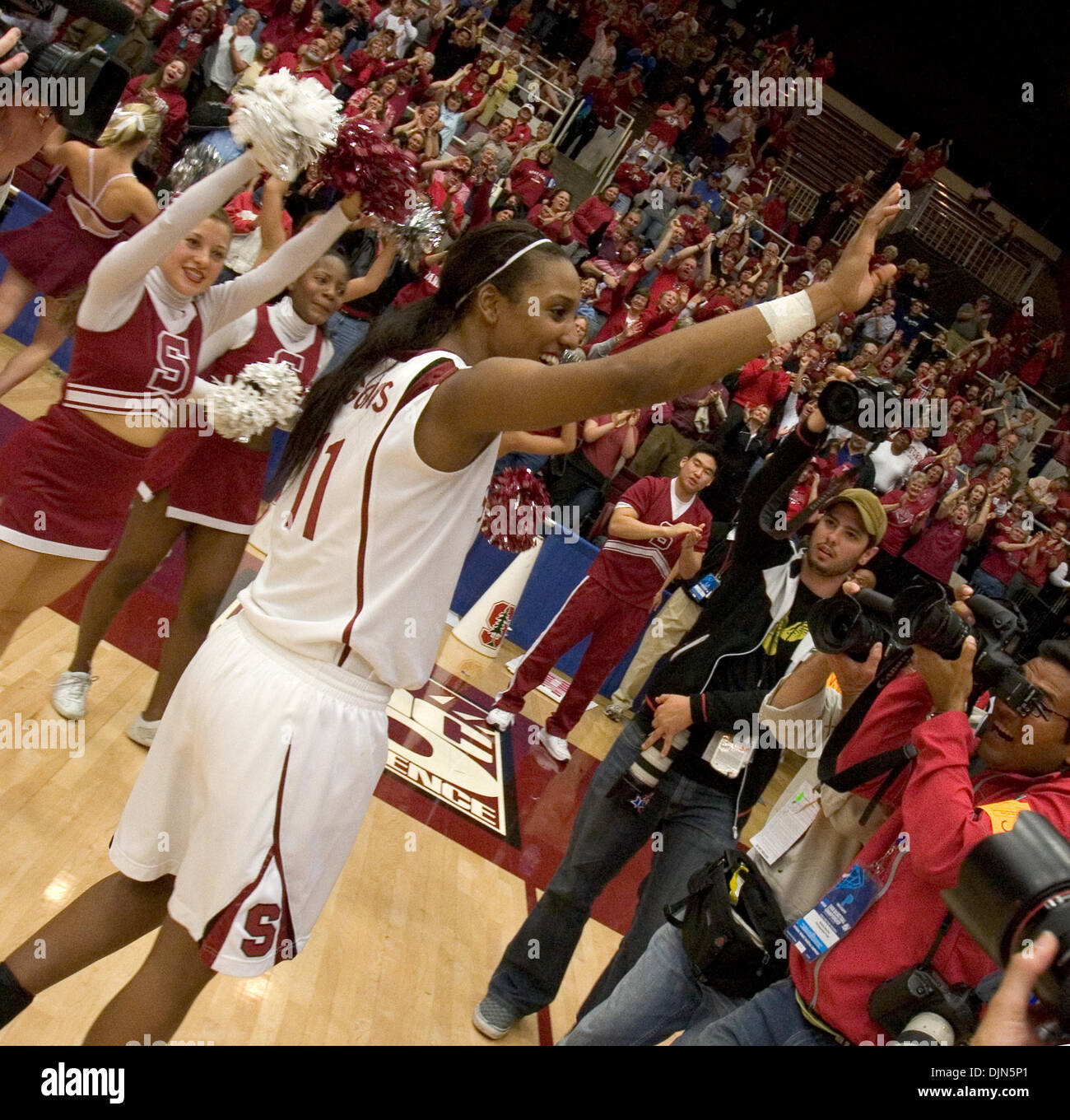 Stanford's Candice Wiggins waves to the crowd as she leaves the court ...