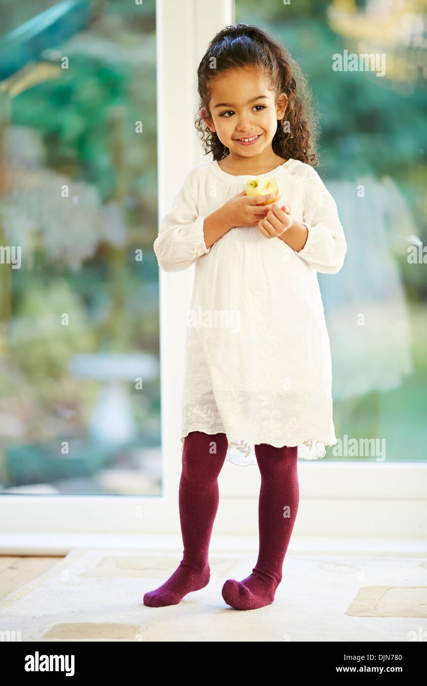 Young girl enjoying eating an apple Stock Photo - Alamy