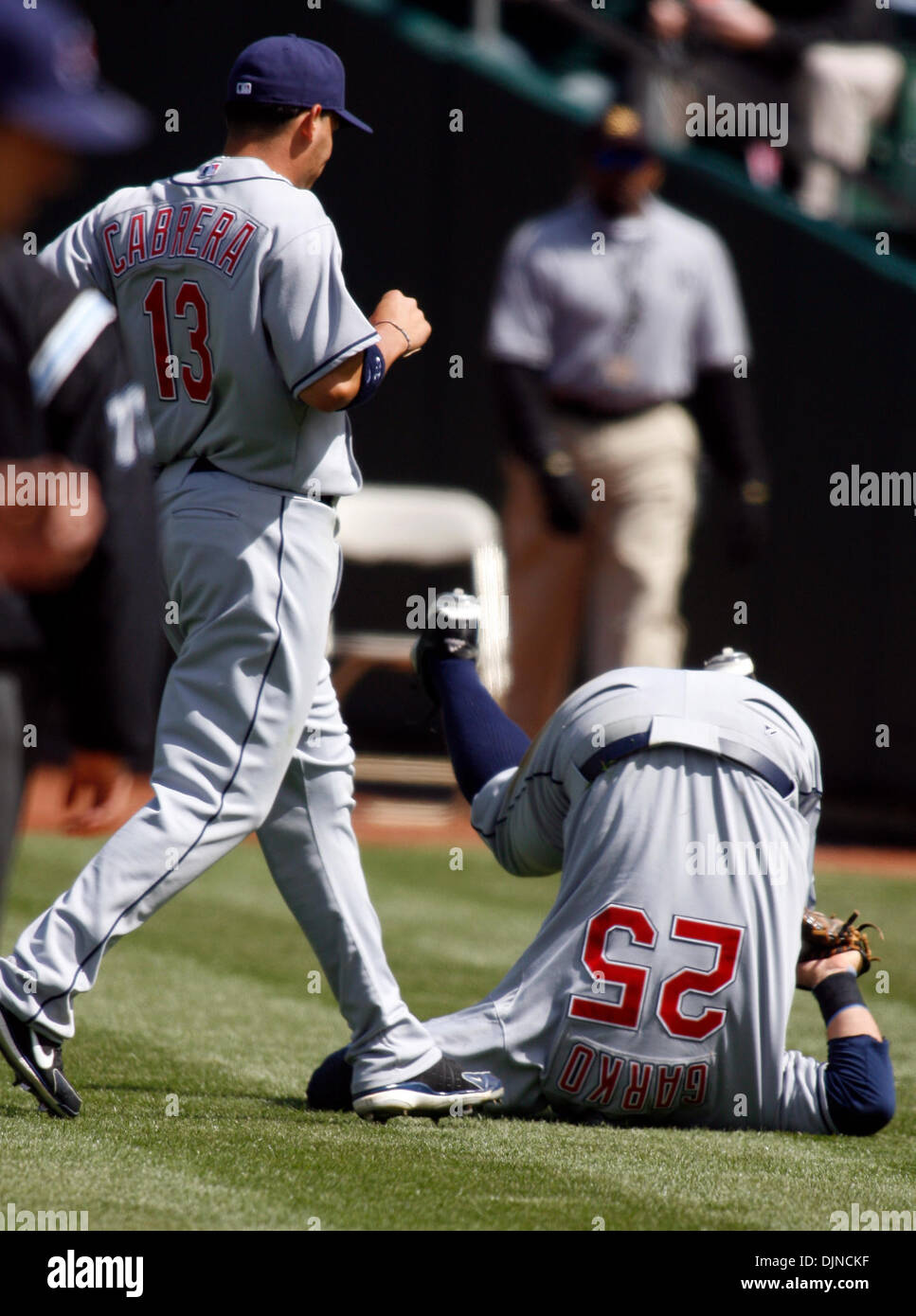 Cleveland Indians first baseman Ryan Garko (25) tumbles over backward ...