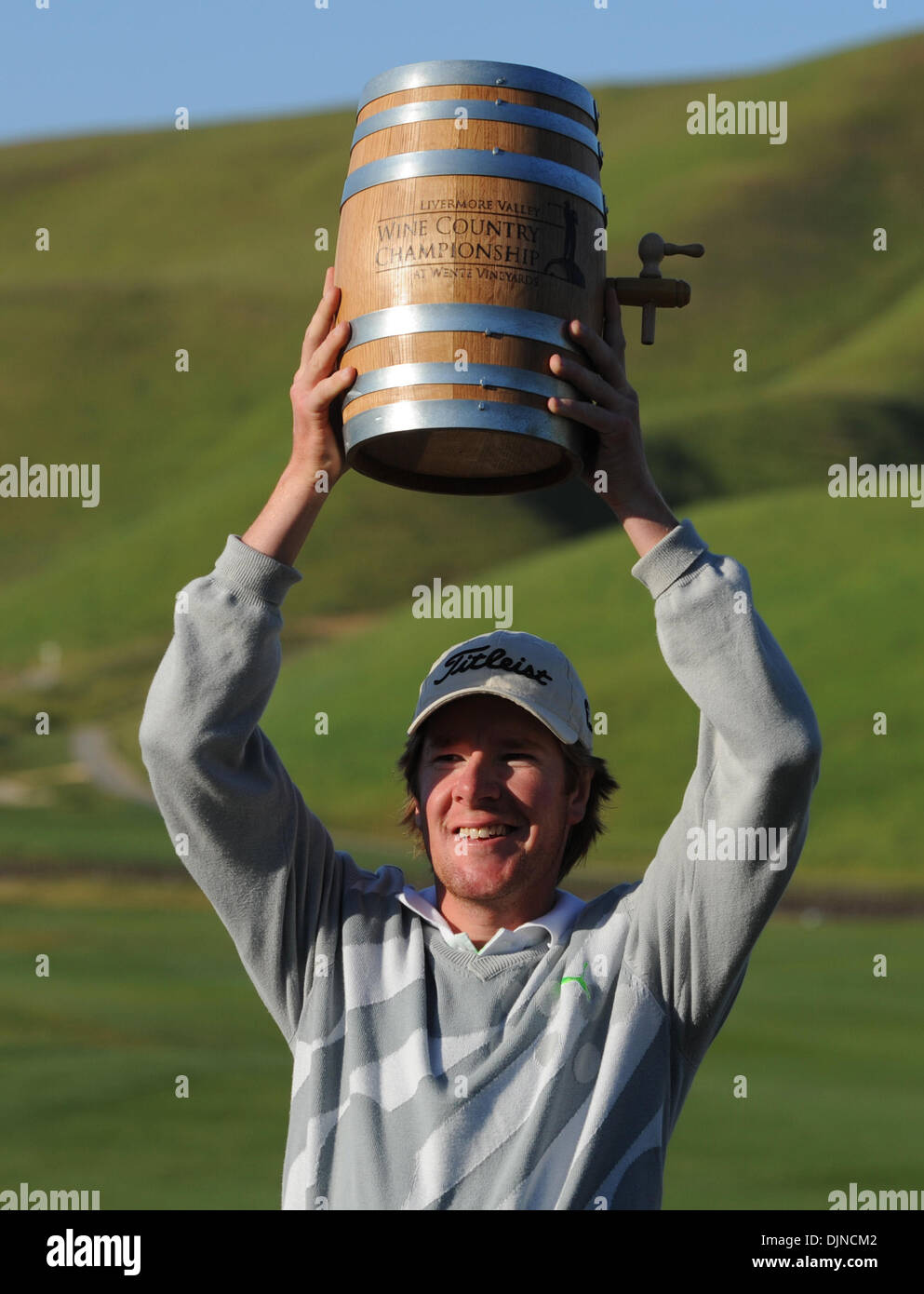 Aron Price, from Sydney, Australia, raises the trophy after winning Nationwide Tour's Livermore ...