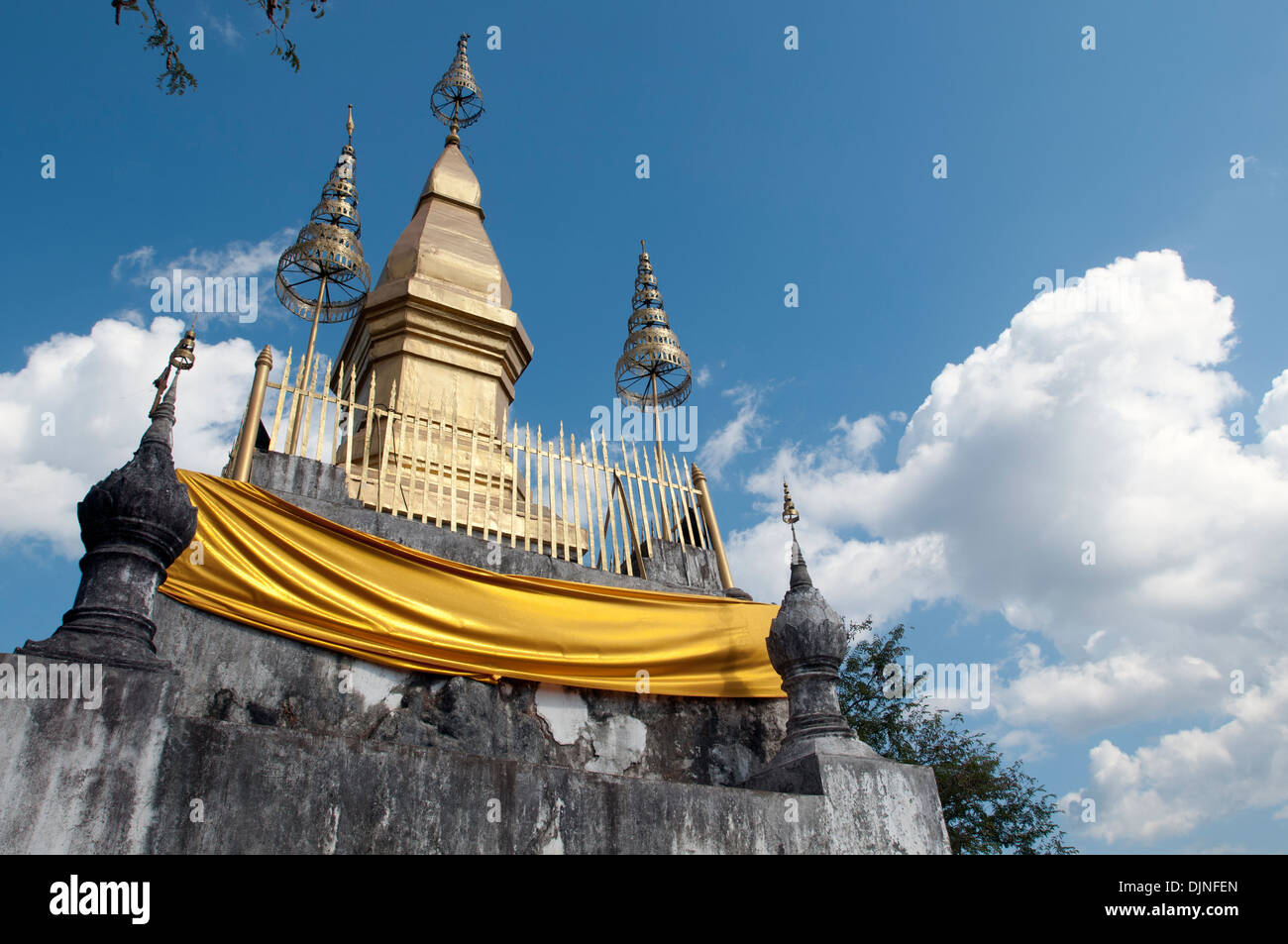 The golden stupa of That Chomsi at the summit of Phousi hill above ...