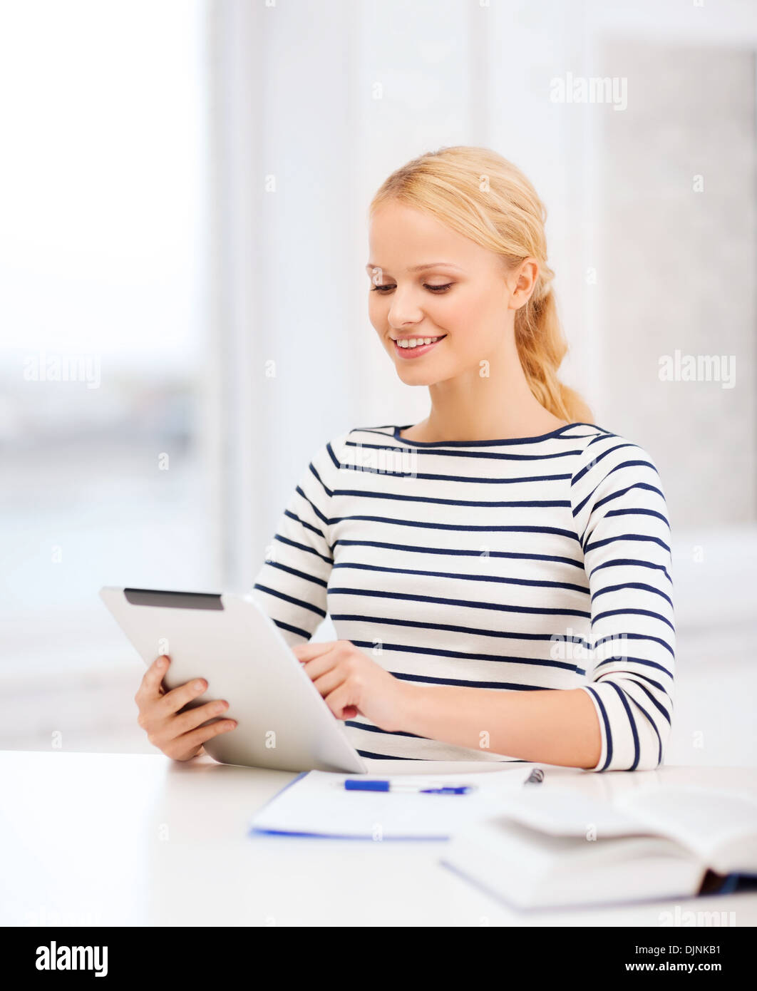 student with tablet pc computer and notebook Stock Photo - Alamy
