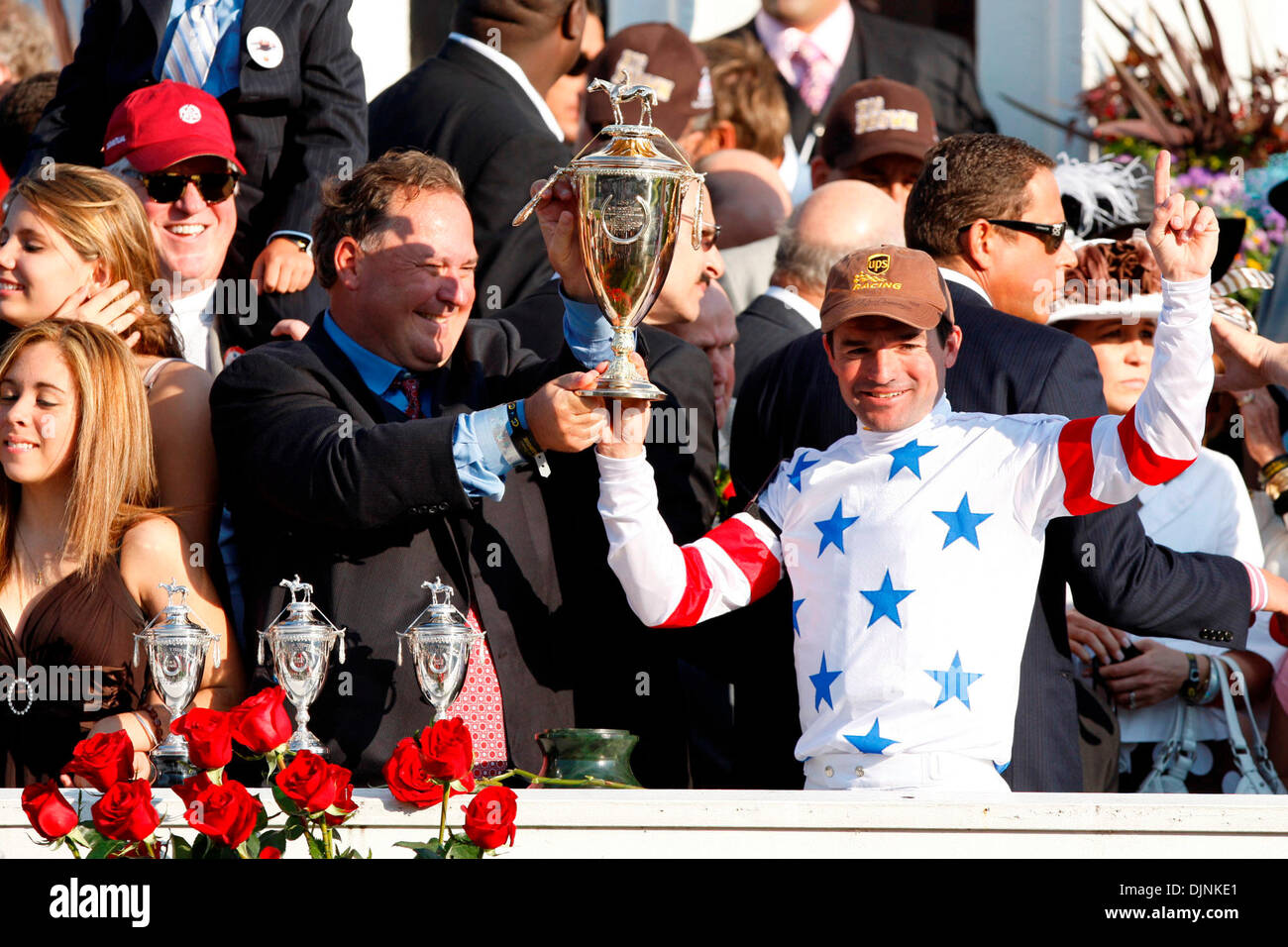 Trainer Richard E. Dutrow Jr. raised the Kentucky Derby Trophy with ...
