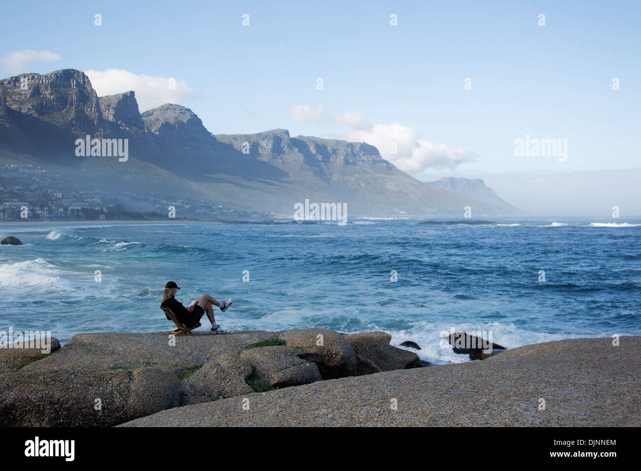 Reading book by the sea Stock Photo - Alamy