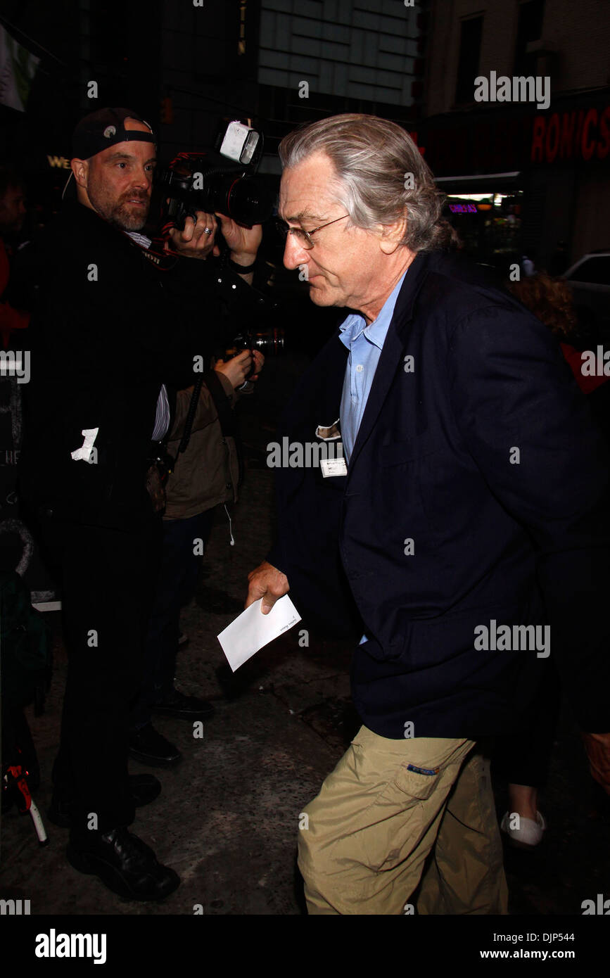 Actor Robert DeNiro avoids press by maneuvering around a woman as he ...