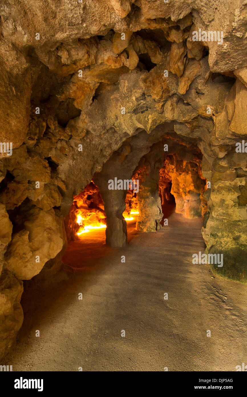 View of a underground cave passage lit with orange lighting Stock Photo ...