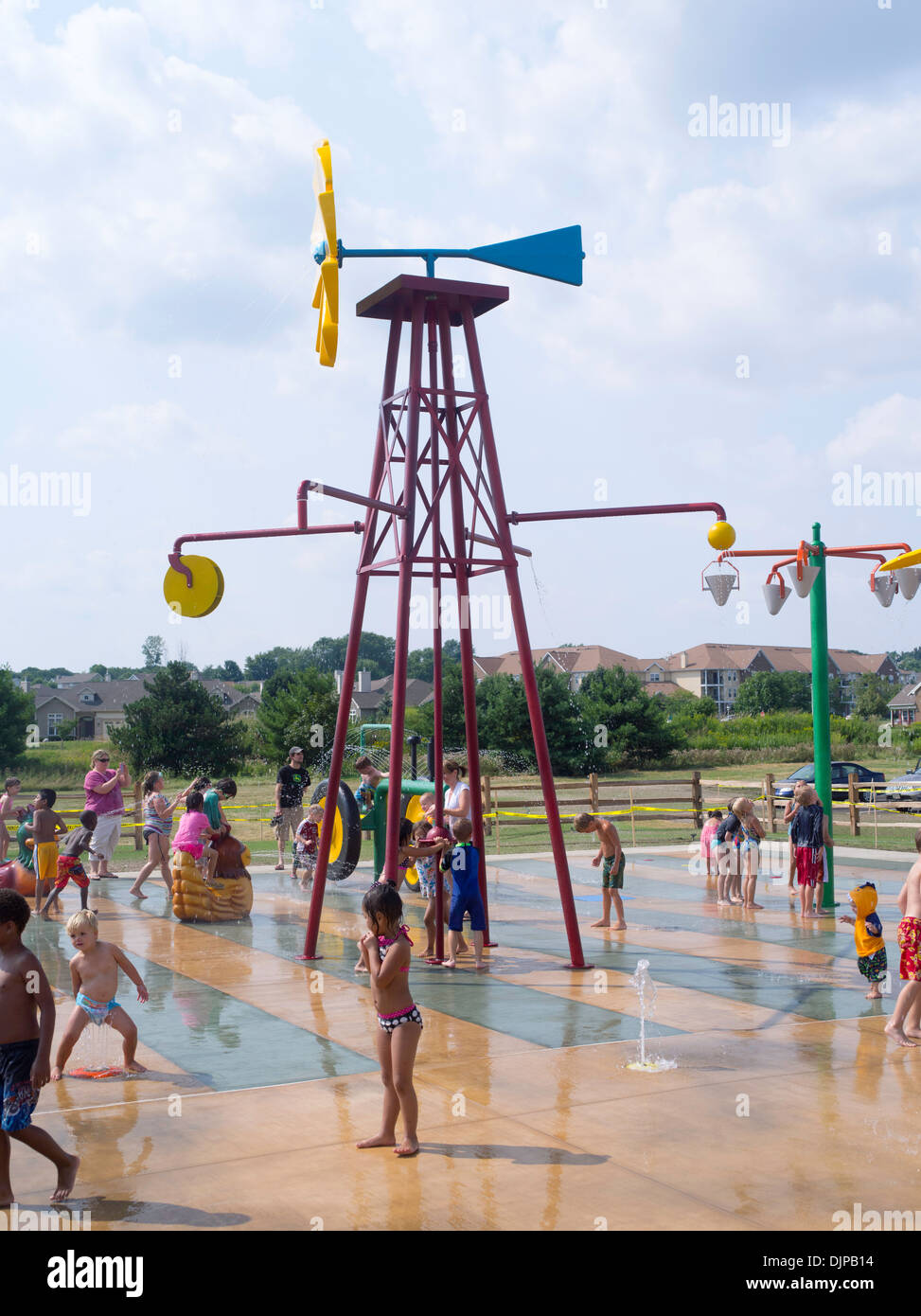 Children and adults play at the new Splash Pad located at McKee Farms ...