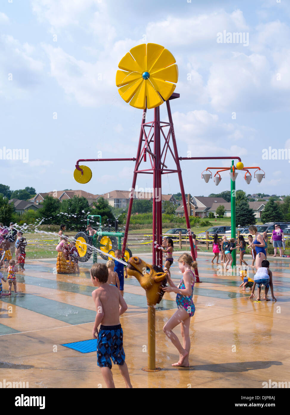 Children and adults play at the new Splash Pad located at McKee Farms ...