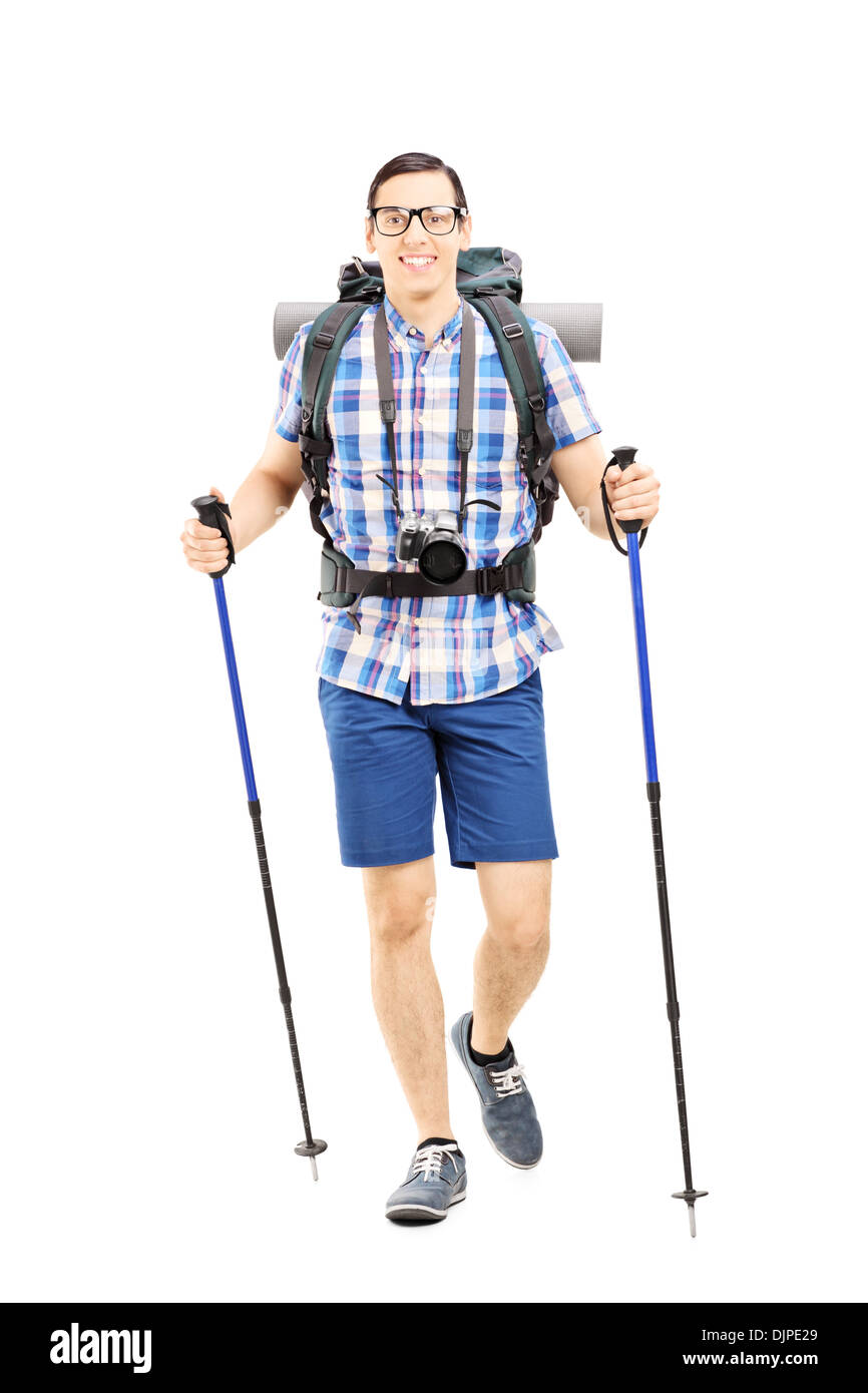 Full length portrait of a smiling hiker with backpack and hiking poles ...