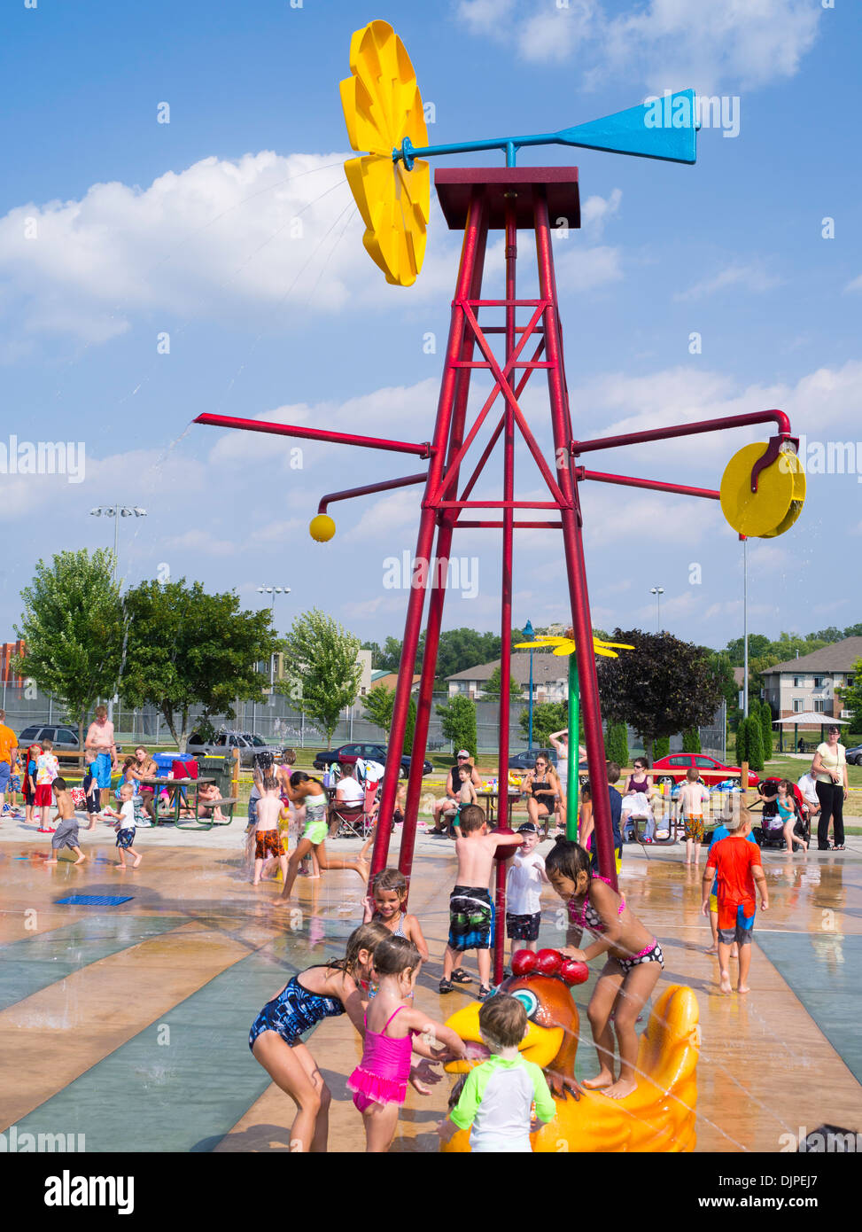 Children and adults play at the new Splash Pad located at McKee Farms ...