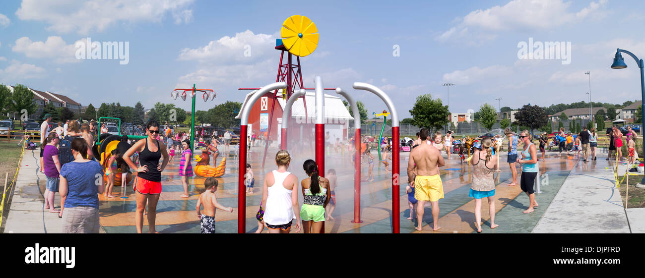 Children and adults play at the new Splash Pad located at McKee Farms ...
