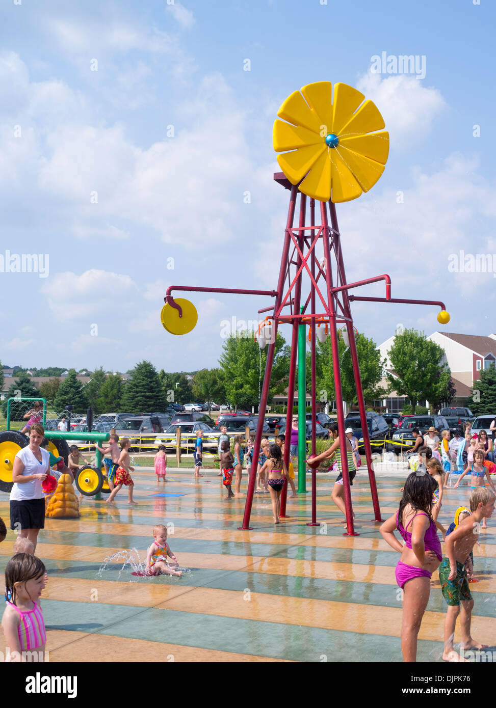 Children and adults play at the new Splash Pad located at McKee Farms ...