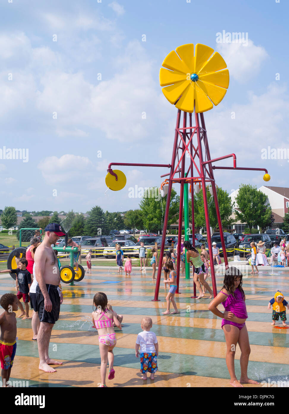 Children and adults play at the new Splash Pad located at McKee Farms ...