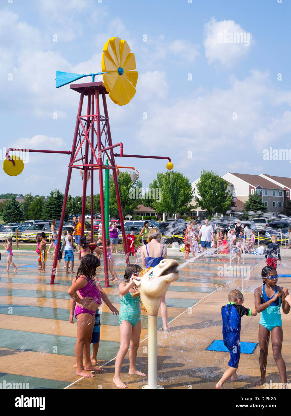 Children and adults play at the new Splash Pad located at McKee Farms ...