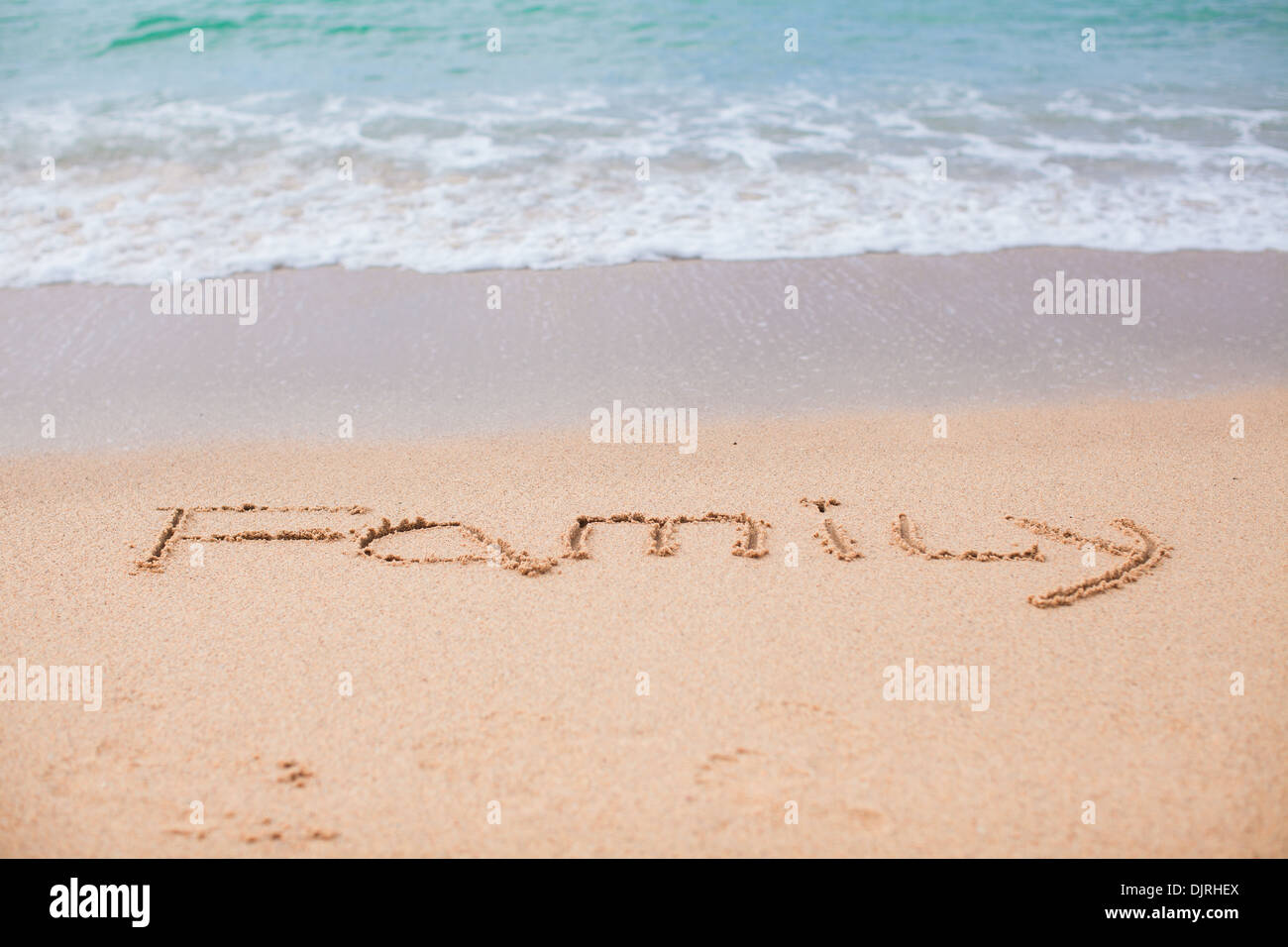 Family drawing in the sand on a tropical beach Stock Photo - Alamy
