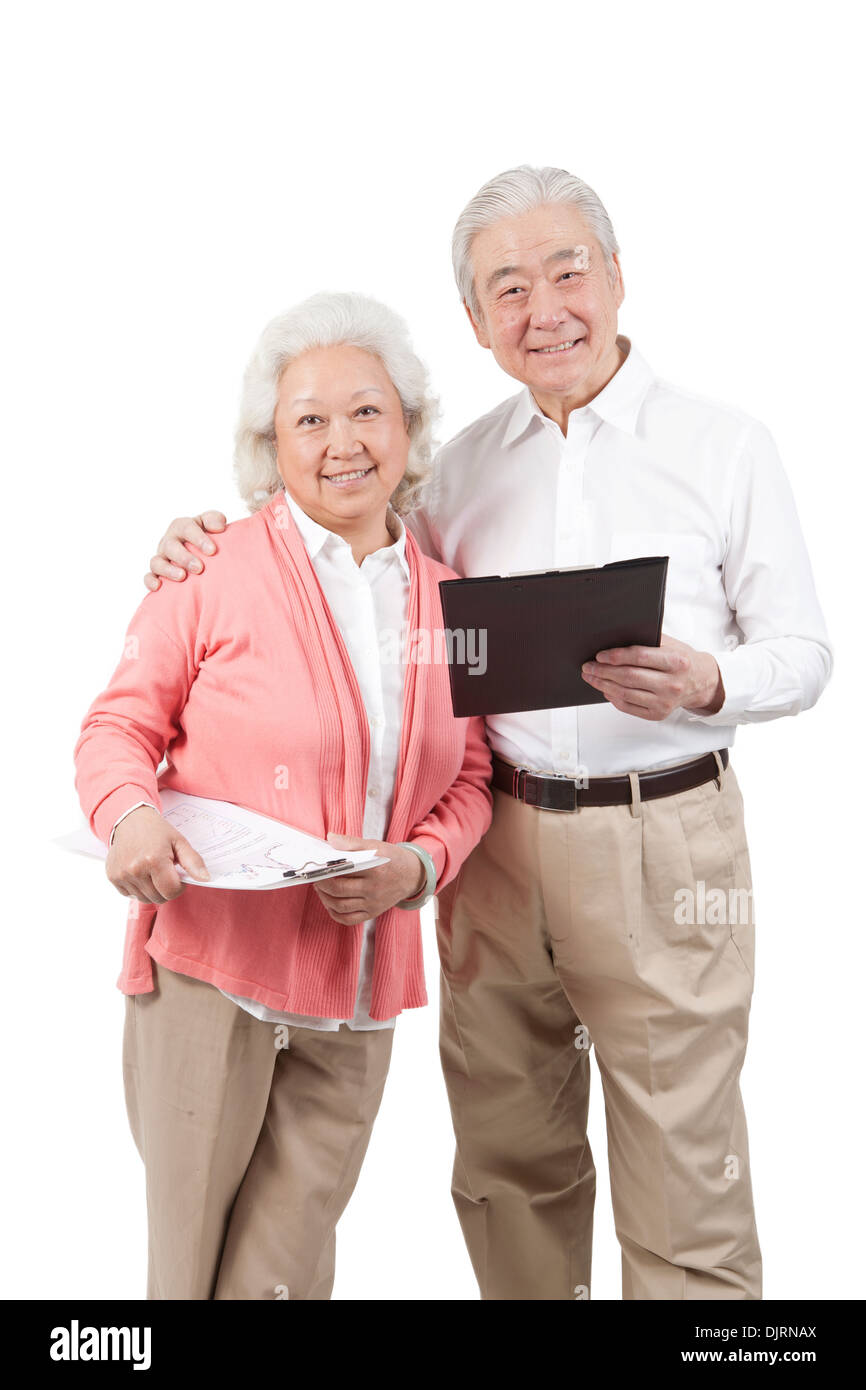 Senior couple holding questionnaire Stock Photo - Alamy