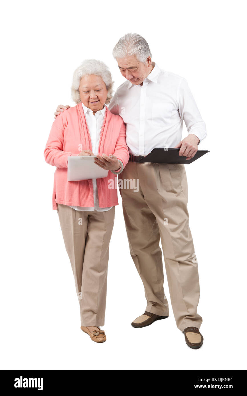 Senior couple holding questionnaire Stock Photo - Alamy