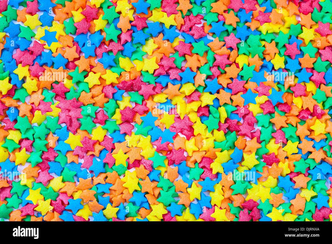 Sugar sprinkles on top of icing birthday cake. Colored glaze decoration ...