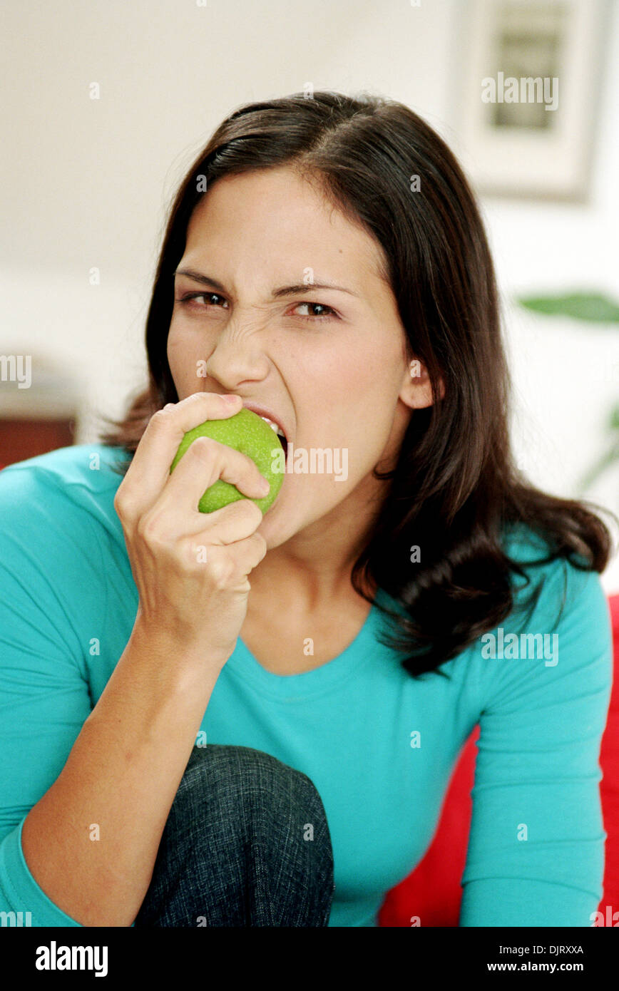 Woman taking a bite from an apple, fruit © Ken Bank / Retna/Photoshot ...