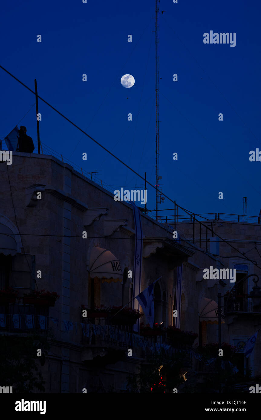 Full moon, a man on roof with camera taking picture Stock Photo - Alamy
