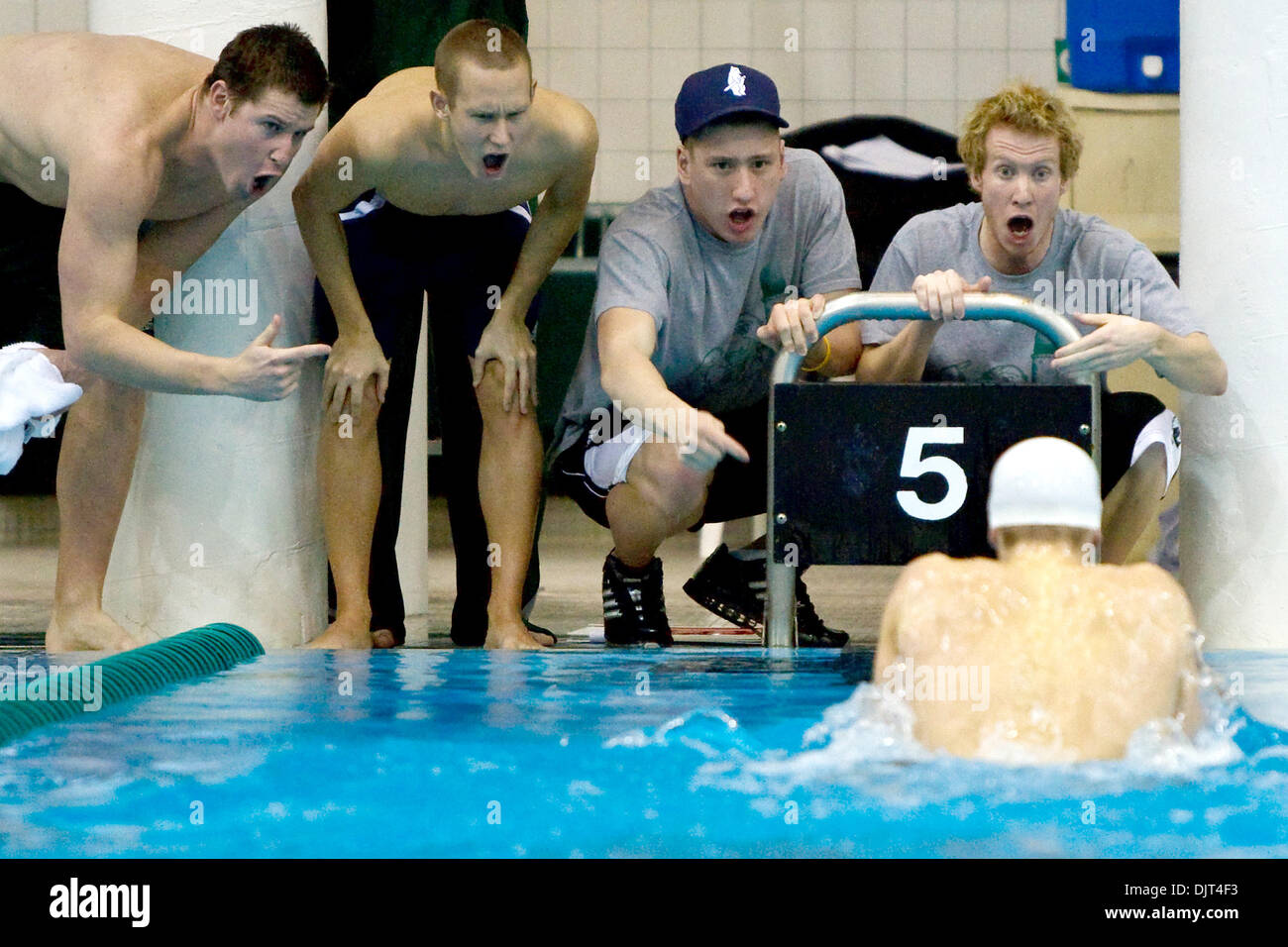Teammates cheer on Eastern Michigan freshman Jacob Hanson as he swims ...
