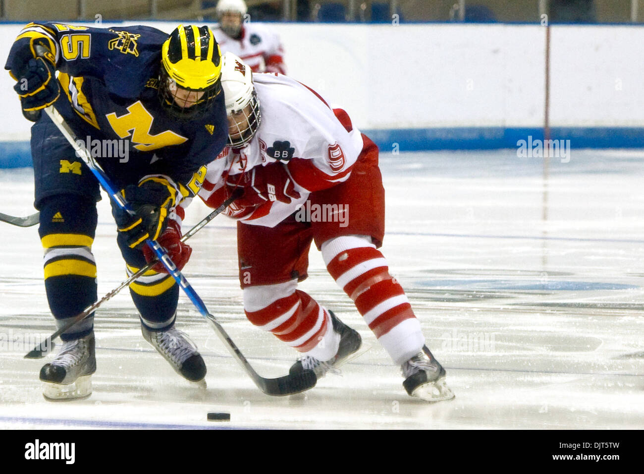 Michigan forward David Wohlberg (25) and Miami forward Tommy Wingels (9 ...