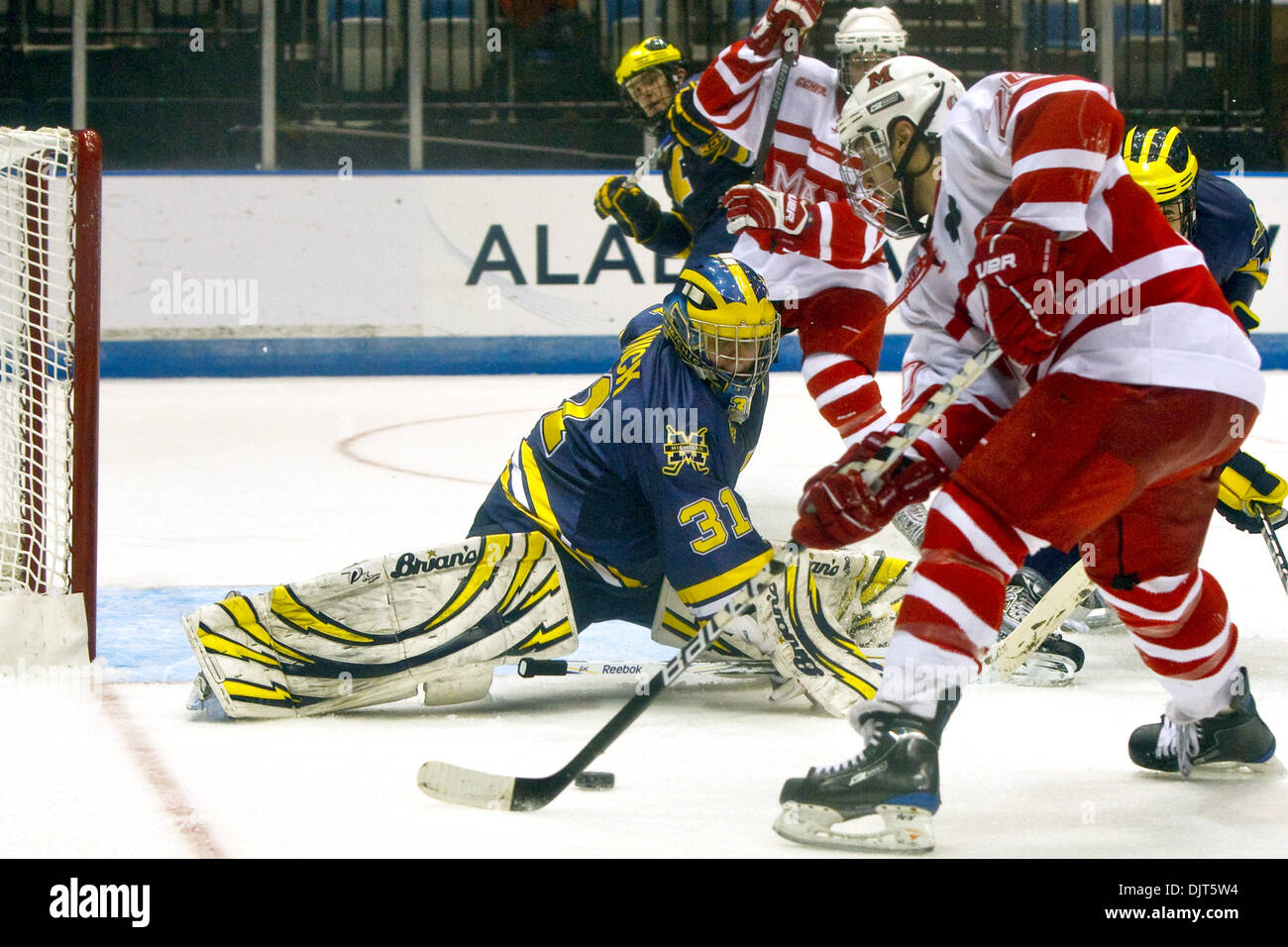 Michigan goaltender Shawn Hunwick (31) tries to block a shot by Miami ...