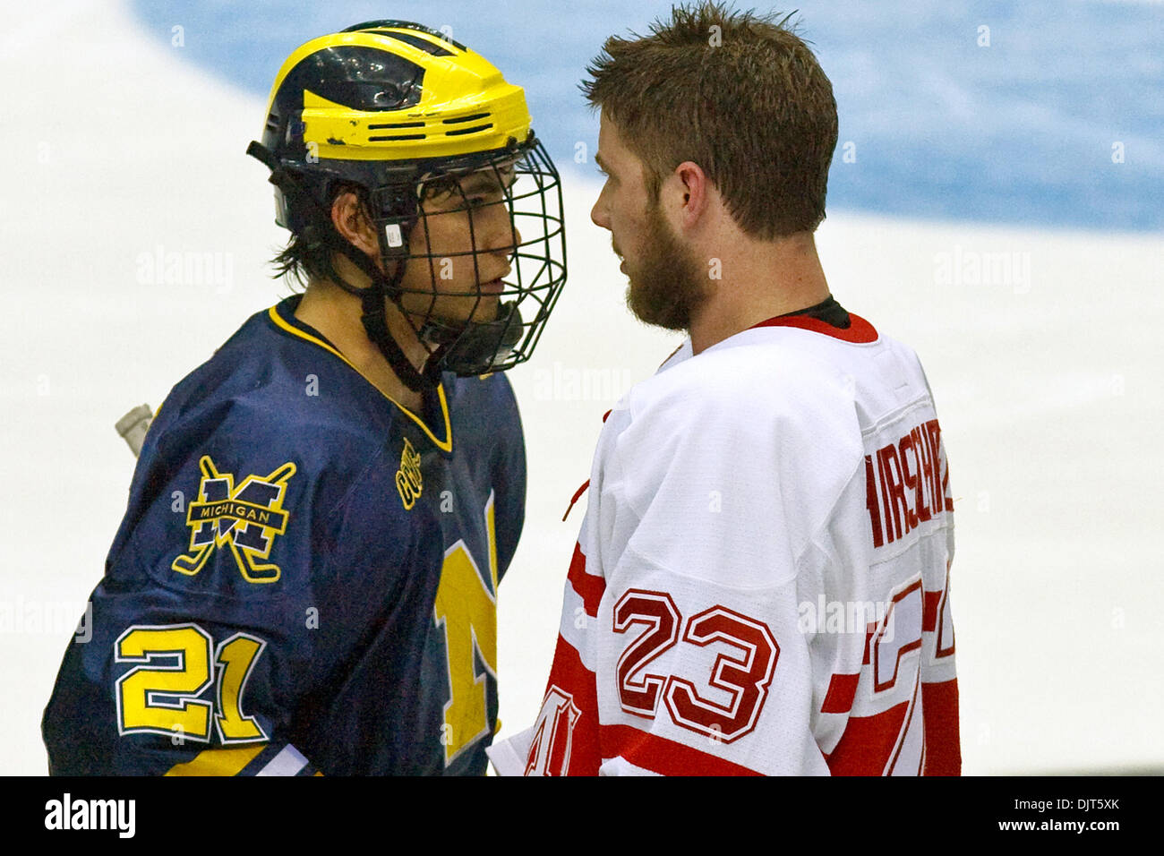 Michigan center AJ Treais (21) congratulates Miami left winger Alden ...