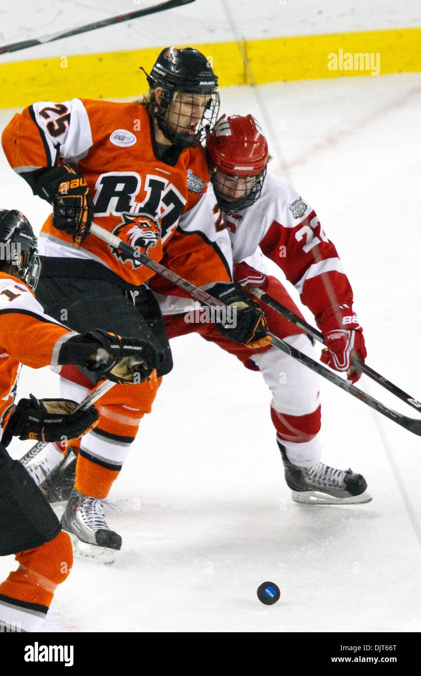 RIT defenseman Daniel Spivak (#25) battles Wisconsin forward Ben Street ...