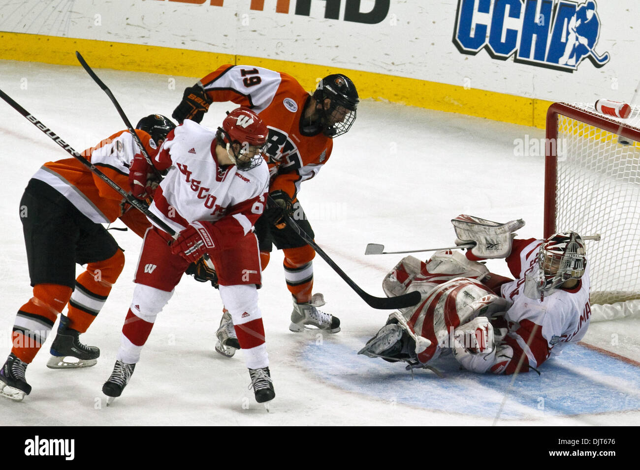 Wisconsin goalie Scott Gudmandson (#1) sprawls on the ice to protect ...