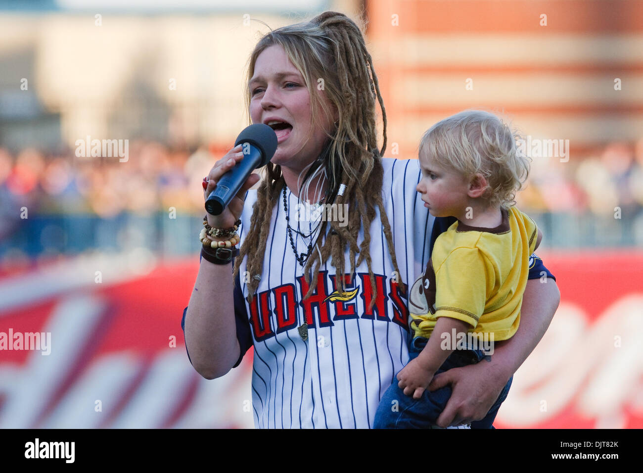 Crystal Bowersox, holding her son Tony, sings the National Anthem ...