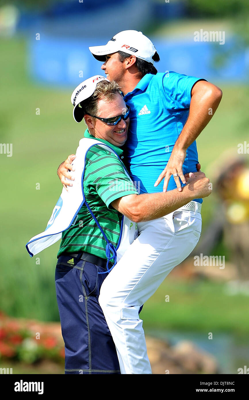 Jason Day embraces his caddie Clin Swatton following his victory at the ...