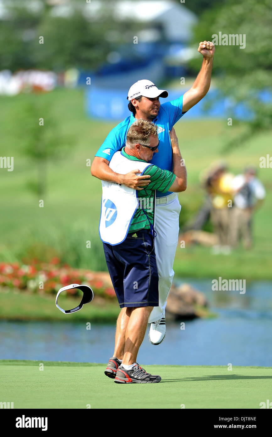 Jason Day embraces his caddie Clin Swatton following his victory at the ...