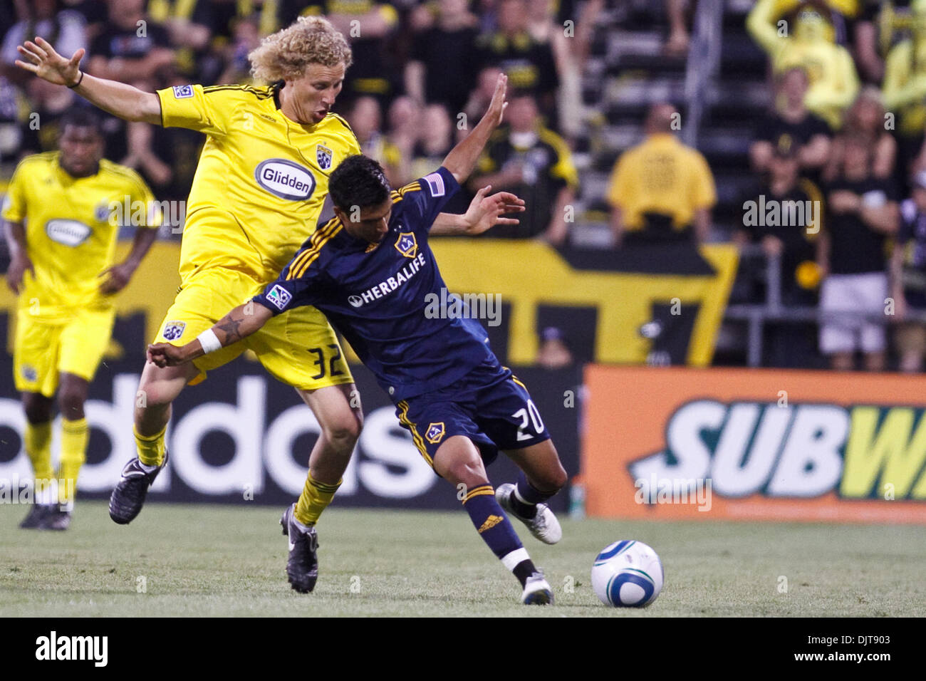 Galaxy defender A.J. DeLaGarza (#20) blocks Crew forward Steven Lenhart ...