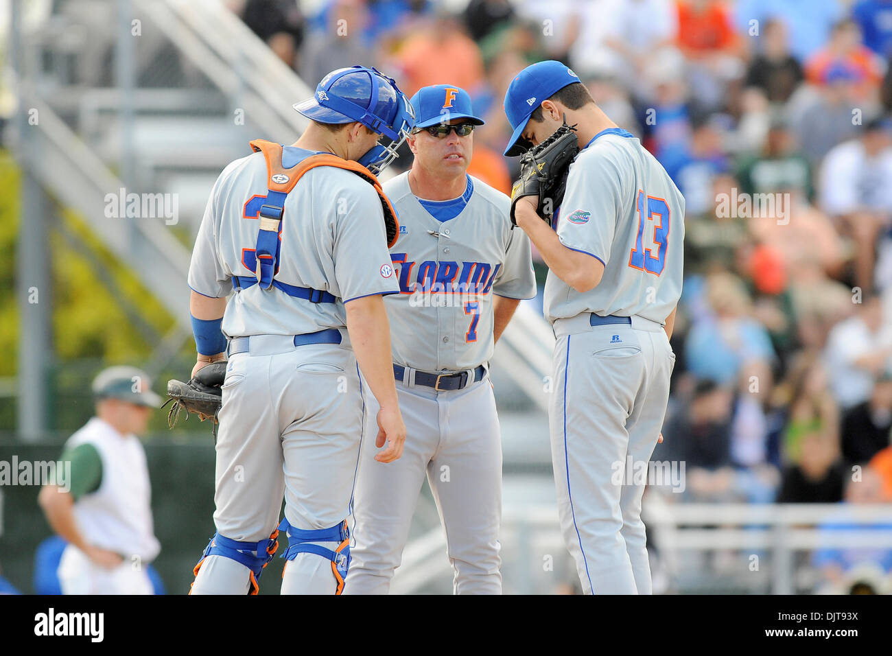 Florida Gators head coach Kevin O'Sullivan has a meeting on the mound ...