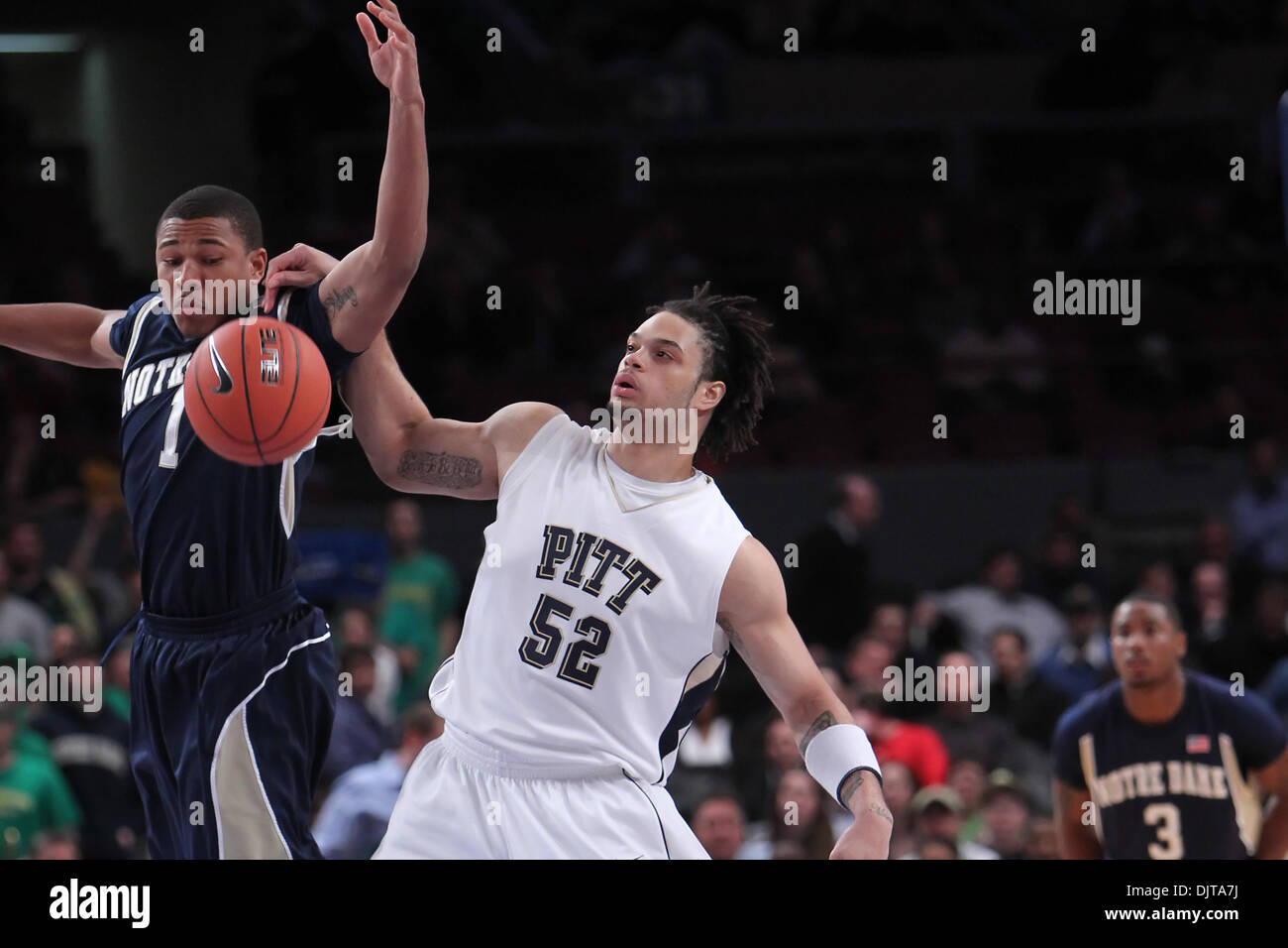 Pittsburgh center Gary McGhee #52 and Notre Dame forward Tyrone Nash #1 ...